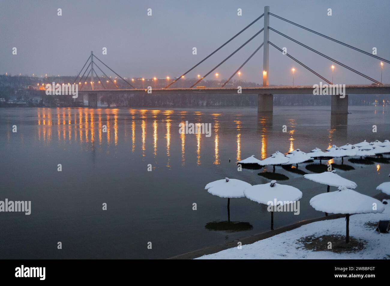 Flooded winter beach with umbrellas in water in night with suspension ...