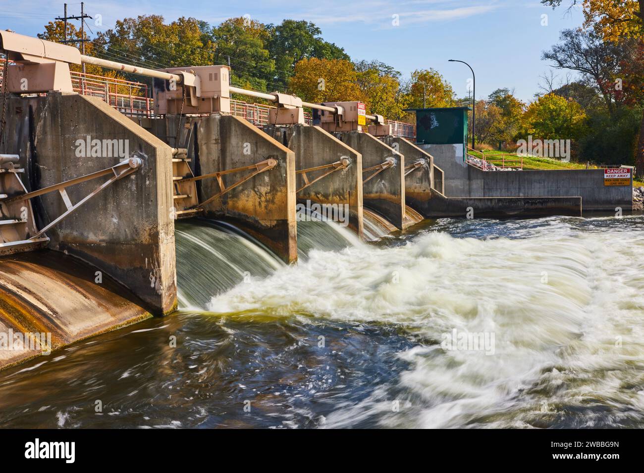 Autumnal Industrial Dam with Flowing Water, Eye-Level View Stock Photo ...