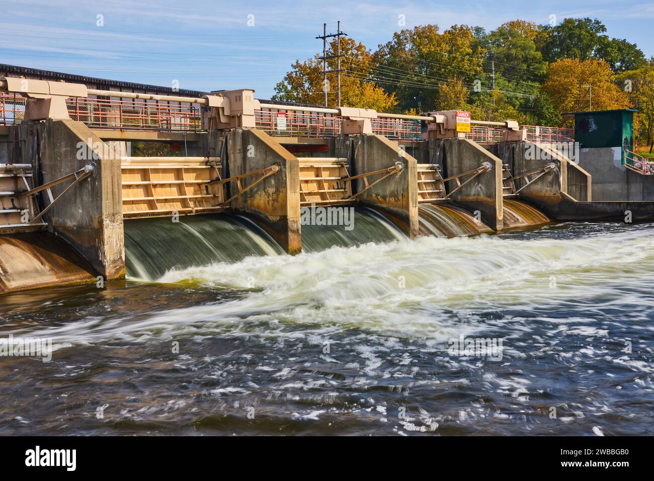 Autumnal Trees and Flowing Dam Water at Huron River, Eye-Level View ...