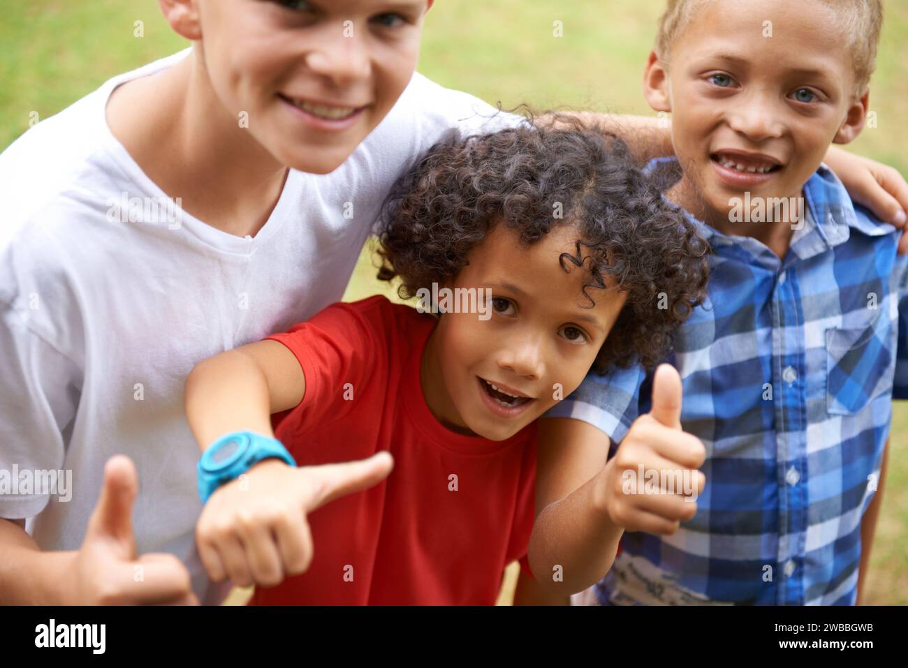 Happy children, portrait and thumbs up at park for teamwork, winning or ...