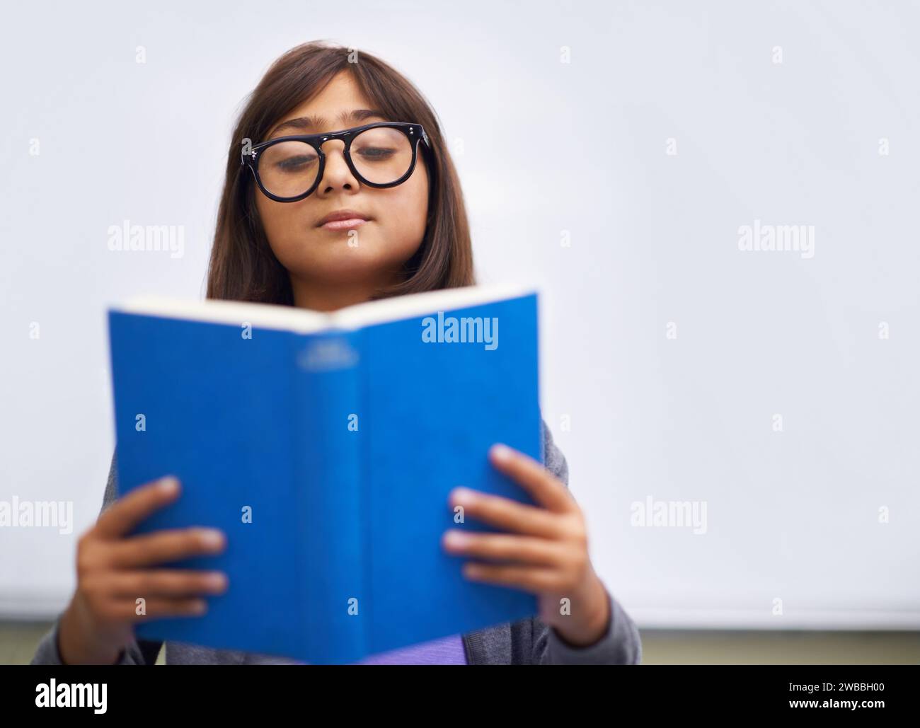 Classroom, child and reading a book for knowledge, information and ...