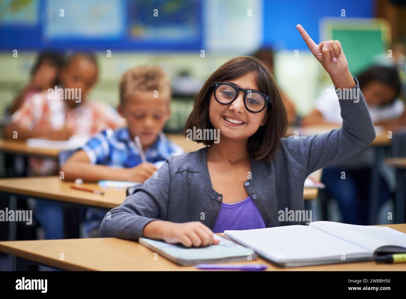 Girl, portrait and raise hand in class, elementary school and answer ...