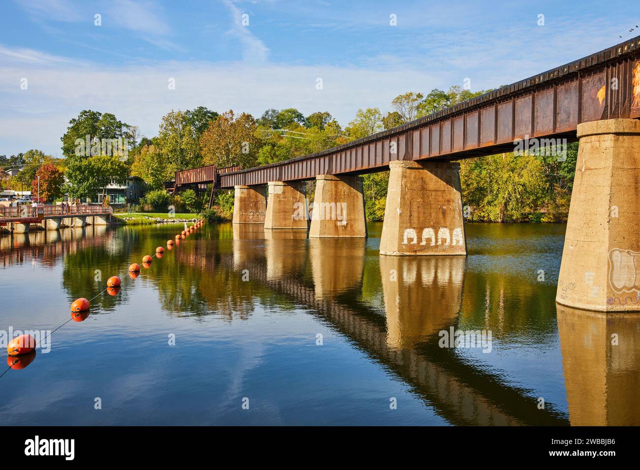 Rustic Railway Bridge Over Huron River with Buoys, Michigan Stock Photo ...