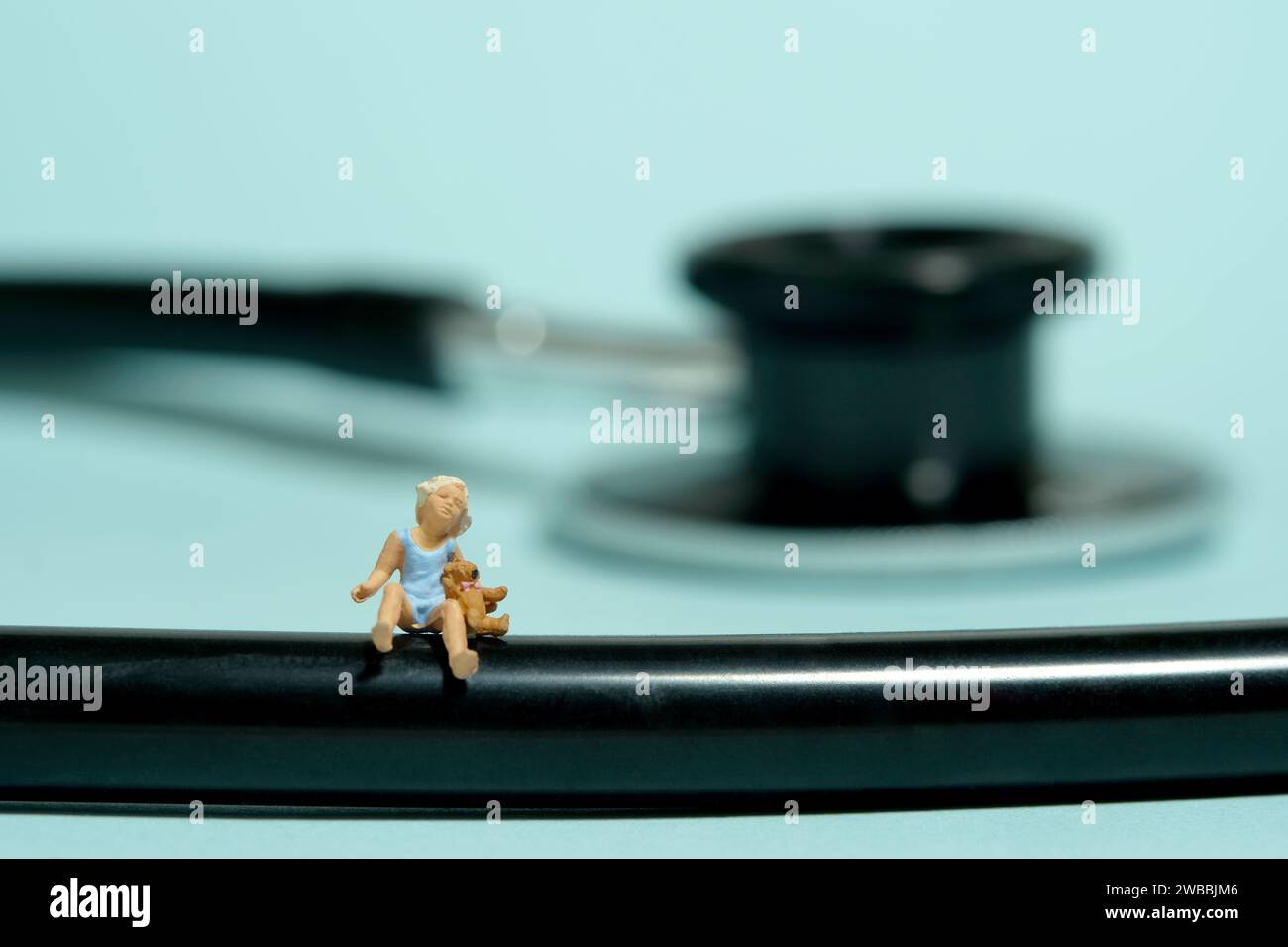 Miniature tiny people toy figure photography. A girl toddler sitting ...