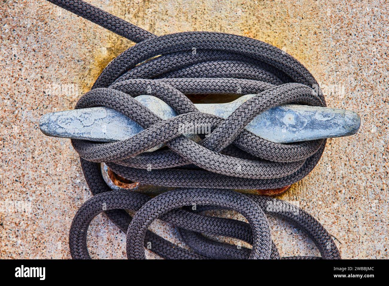 Braided Rope on Weathered Dock Cleat, Nautical Detail Stock Photo - Alamy