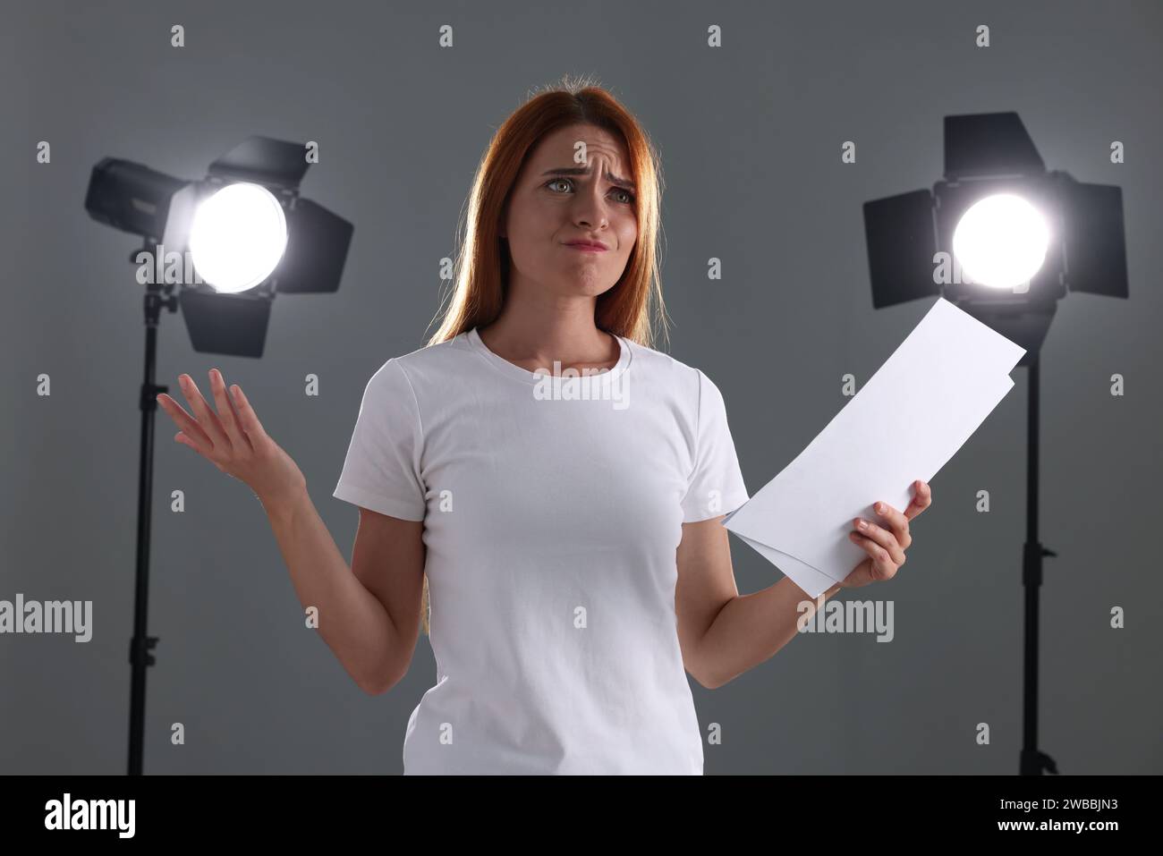 Casting call. Emotional woman with script performing on grey background ...