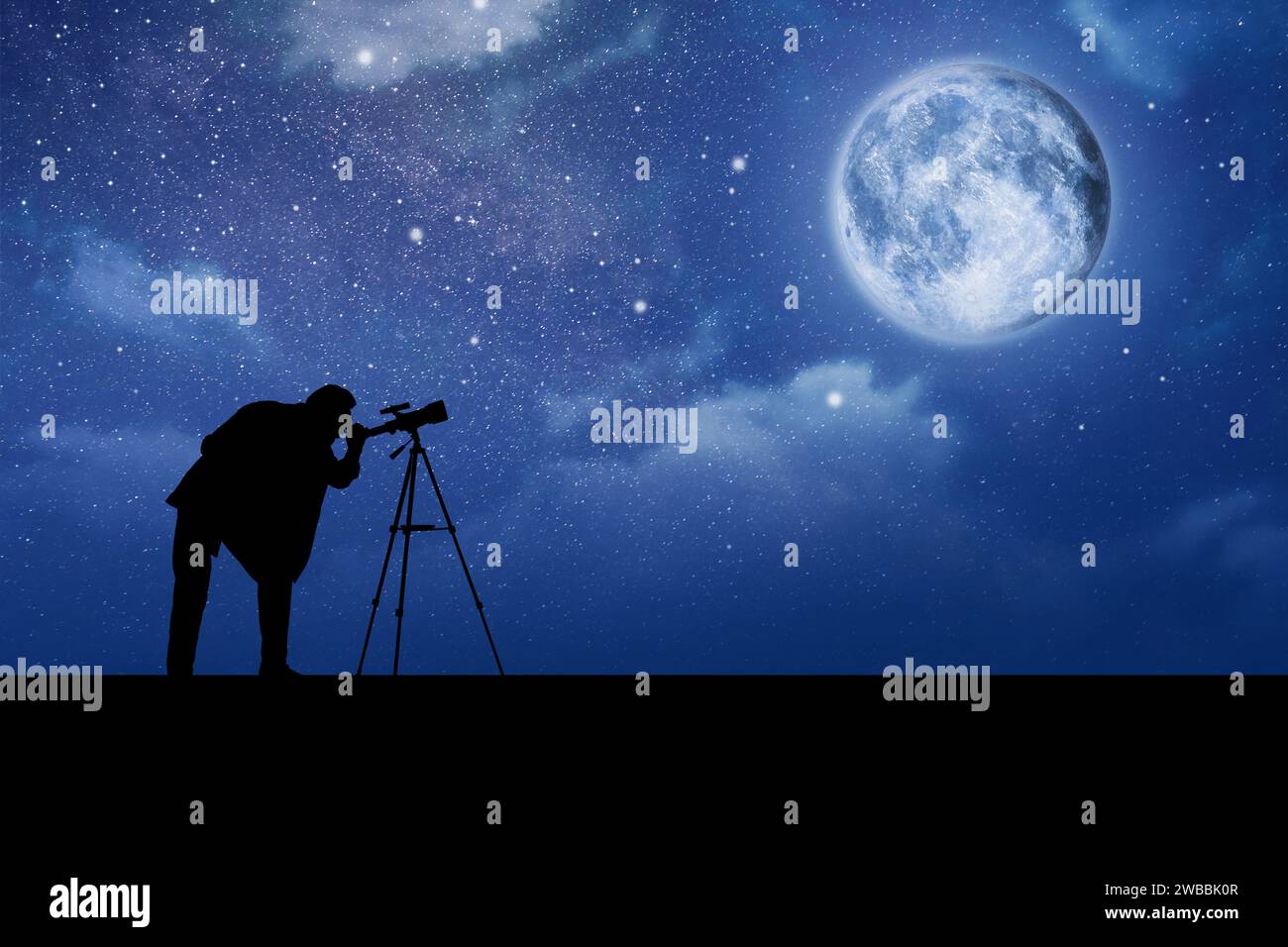 Astronomer looking at moon and stars through telescope outdoors Stock ...