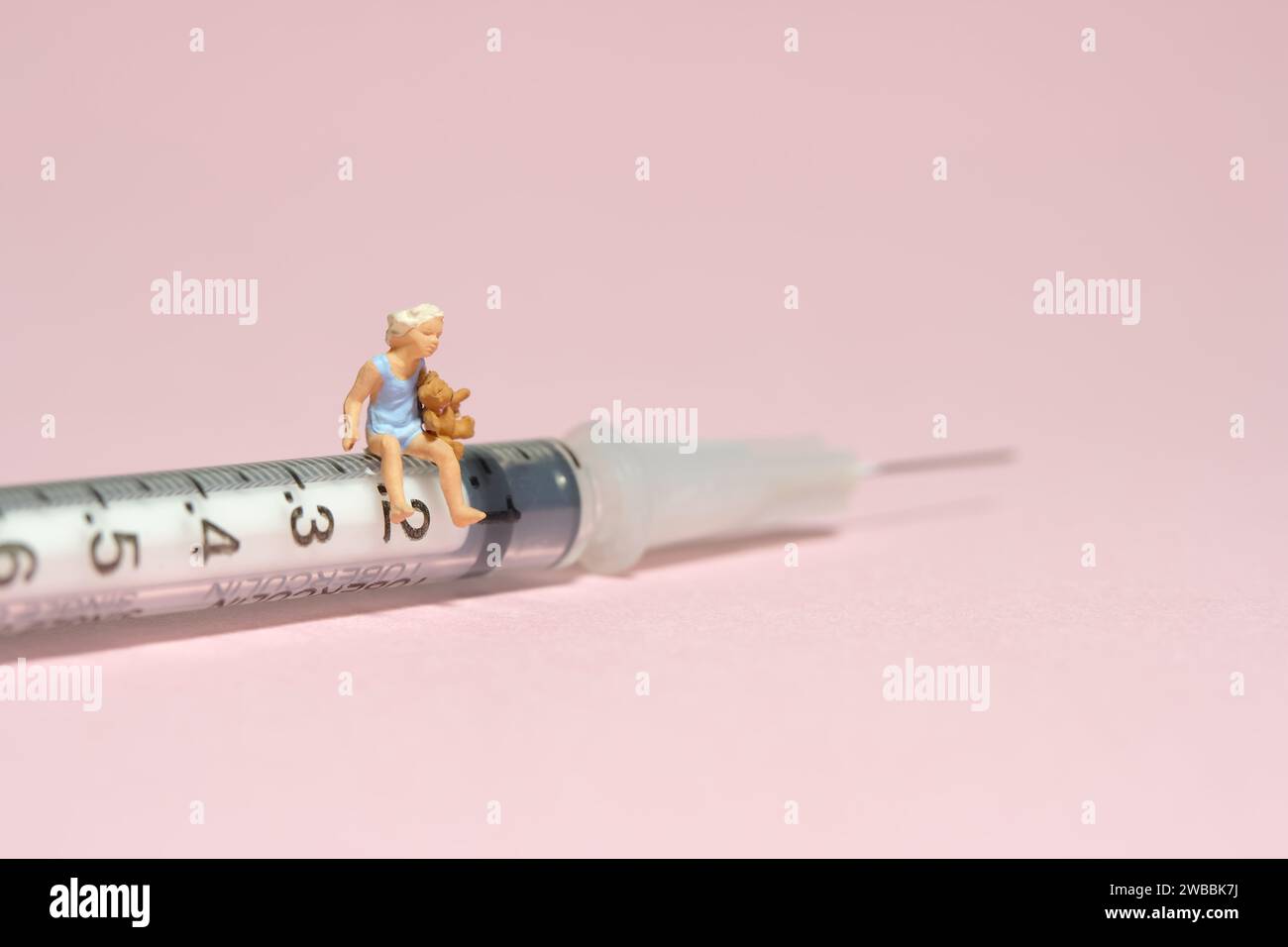 Miniature tiny people toy figure photography. A girl toddler sitting ...