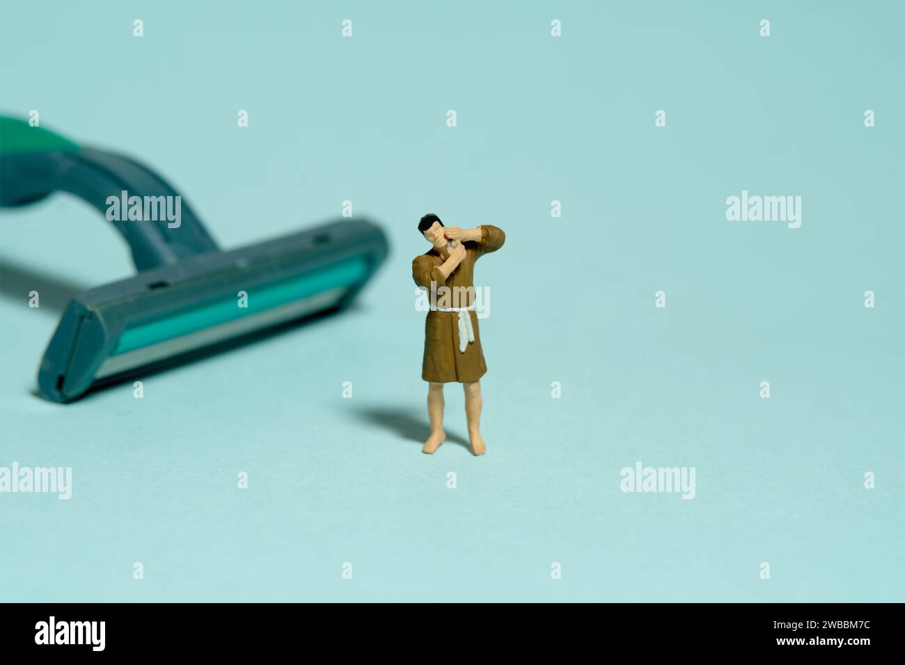 Miniature tiny people toy figure photography. A man wearing bathrobe ...