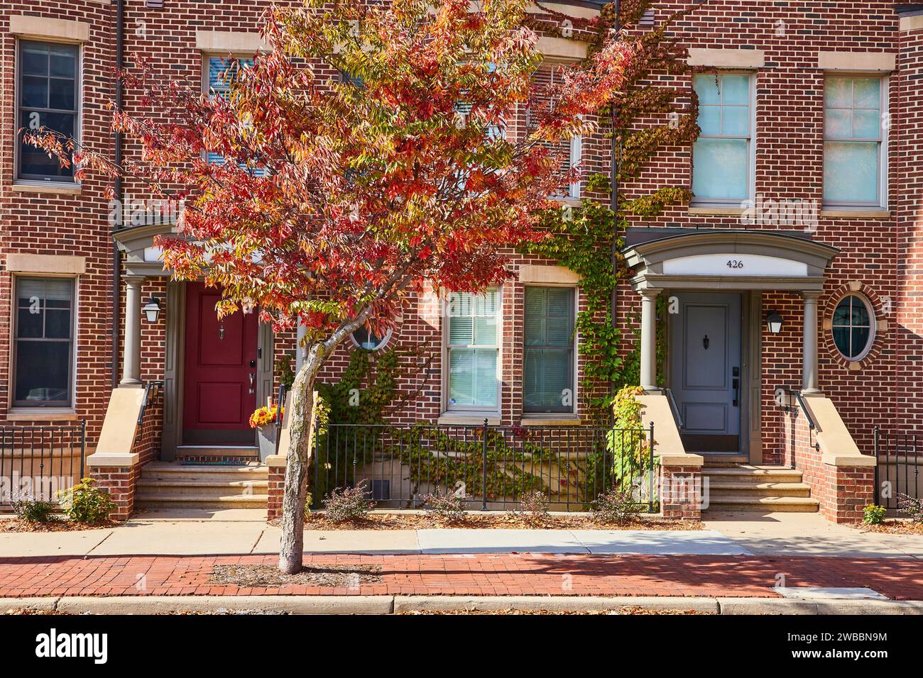 Autumn Townhouses with Red Brick Facades and Iron Railings Stock Photo ...