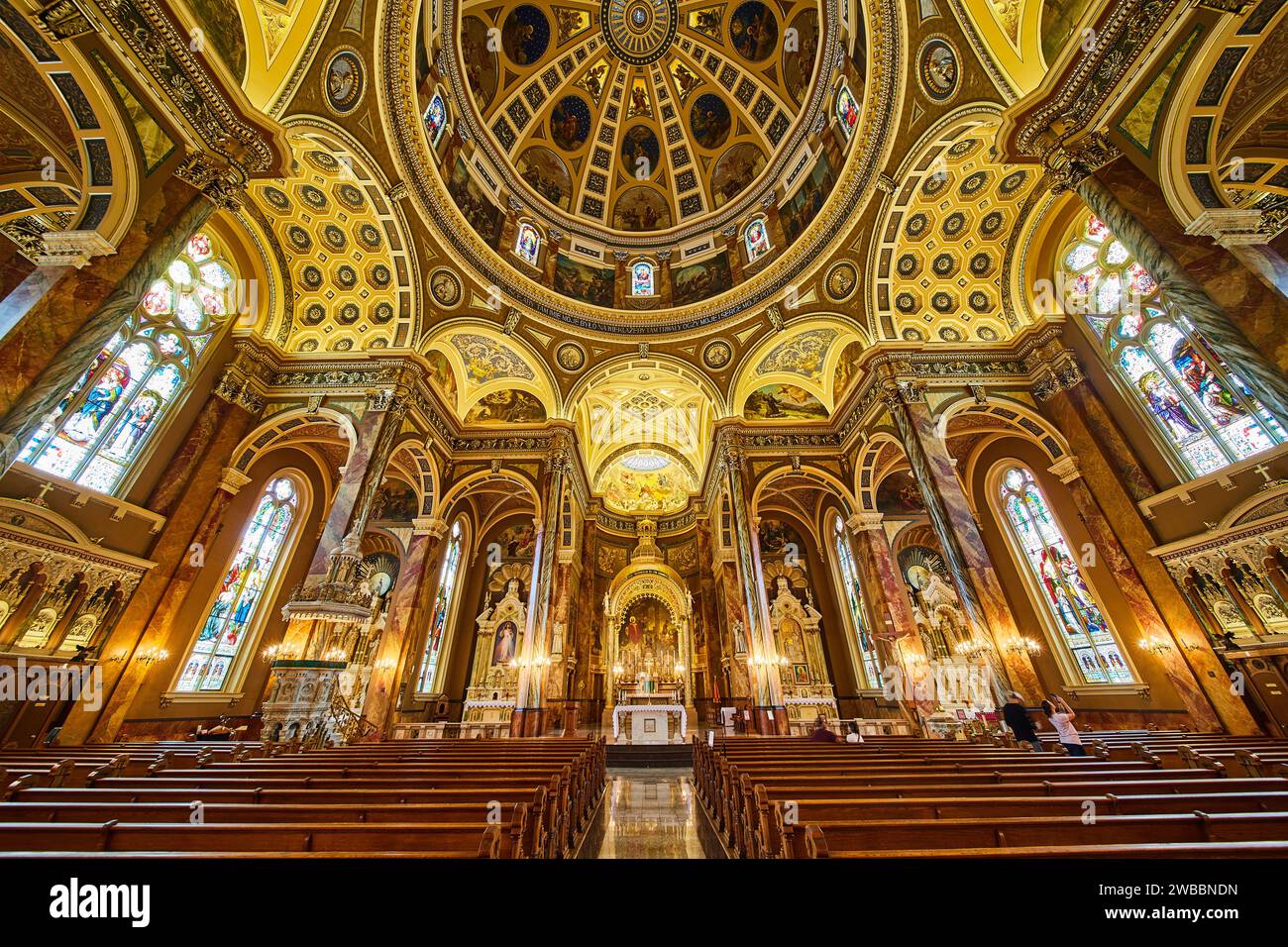 Ornate Cathedral Interior with Golden Ceiling and Stained Glass Stock ...