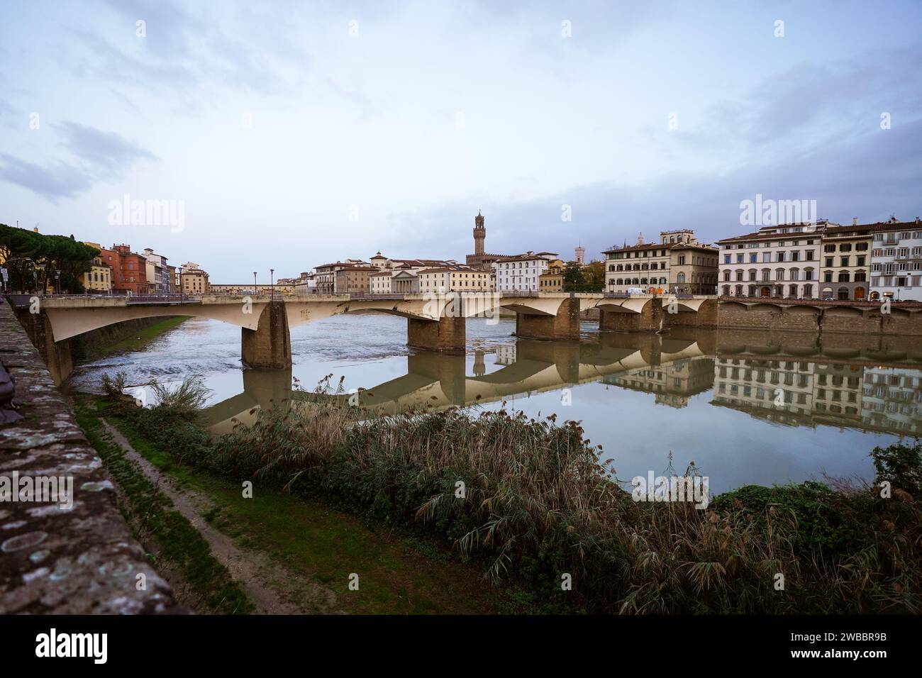 Arno river with bridges and surrounding buildings in Florence, Italy ...