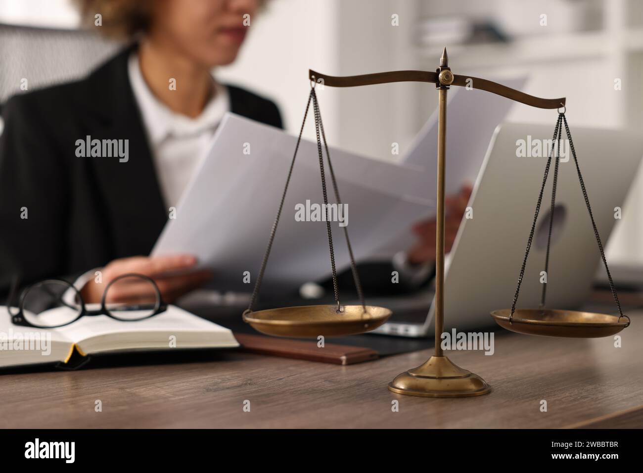 Notary working with documents at workplace in office, focus on scales ...