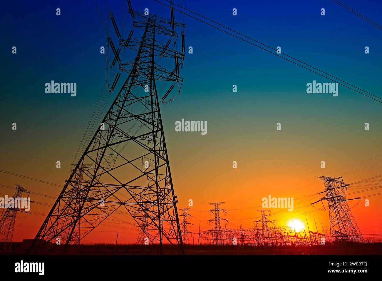 Pylon, high-voltage tower sky background Stock Photo - Alamy