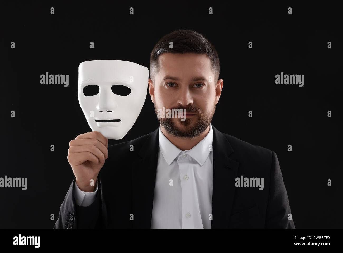 Multiple personality concept. Man with mask on black background Stock ... Multiple personality concept. Man with mask on black background Stock ...