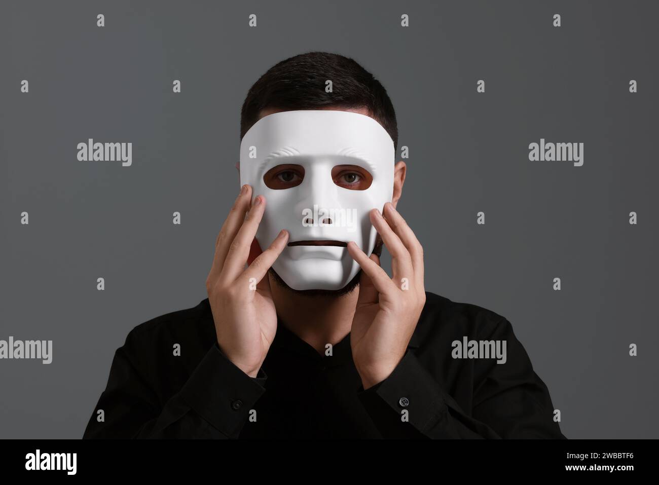 Multiple personality concept. Man in mask on grey background Stock ...