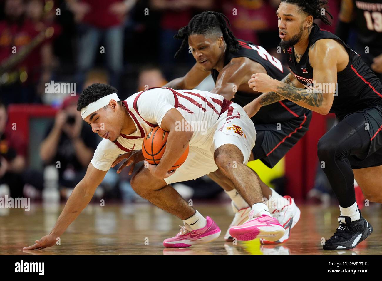 Iowa State guard Tamin Lipsey, left, fights for a loose ball with ...