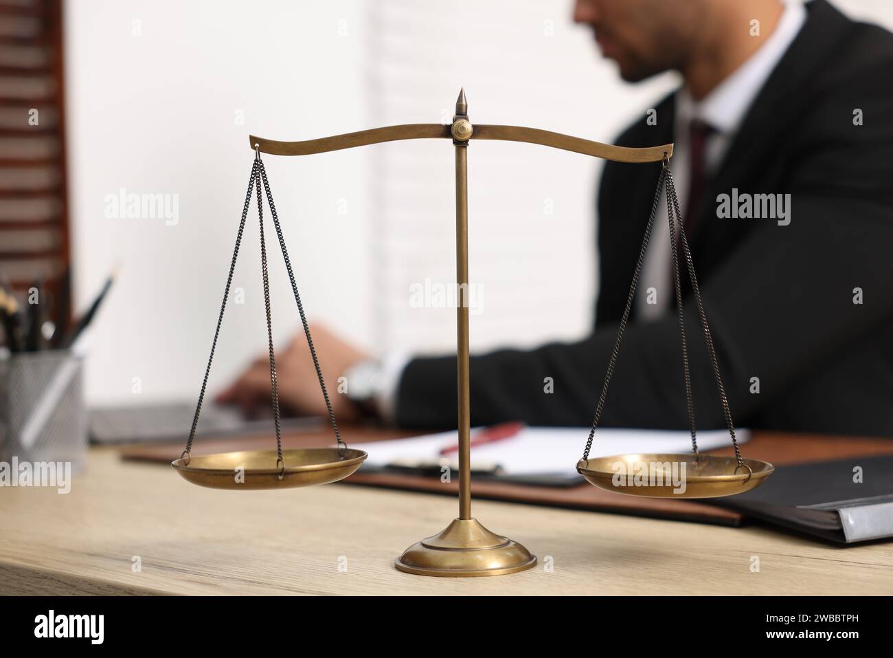 Lawyer working at table in office, focus on scales of justice Stock ...