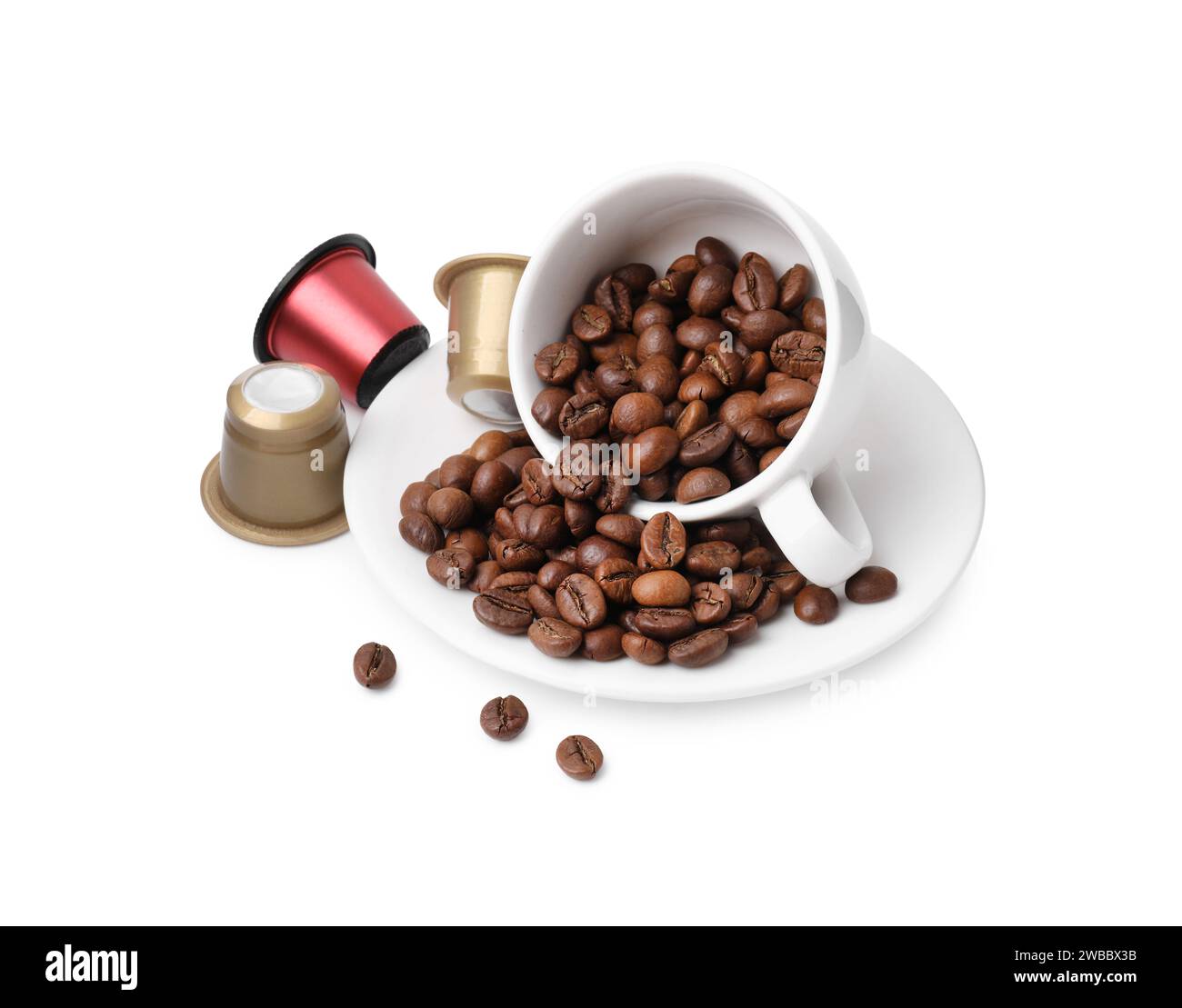 Coffee capsules, beans, cup and saucer isolated on white Stock Photo ...