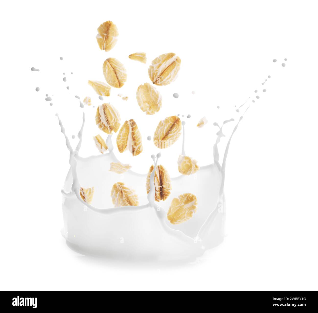 Rolled oats falling into splashing milk on white background Stock Photo ...