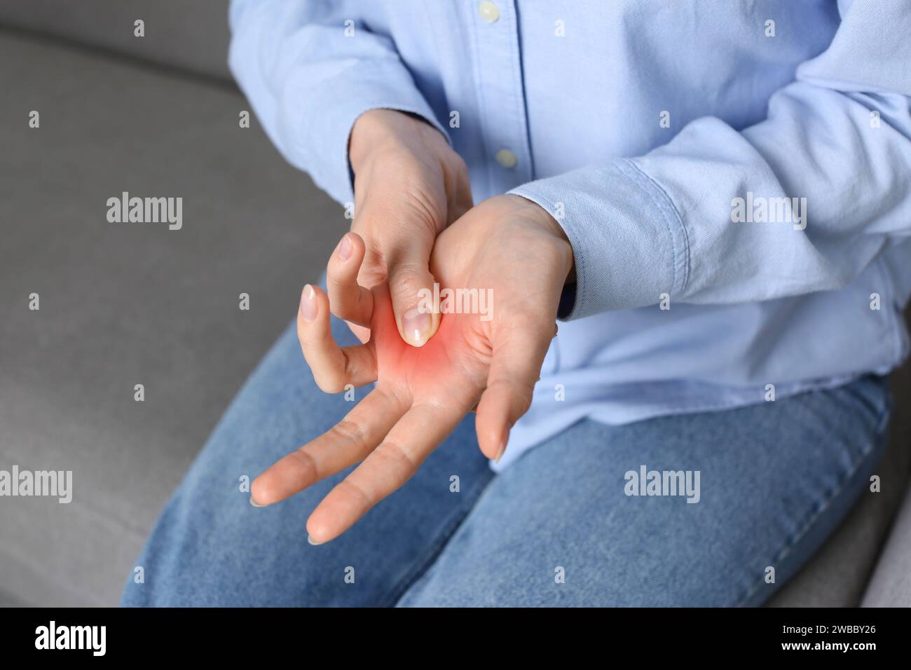 Woman suffering from trigger finger on sofa, closeup Stock Photo - Alamy