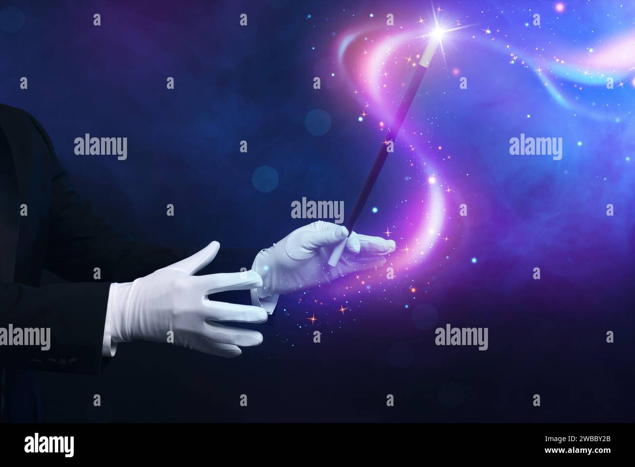 Magician with wand showing trick on dark blue background, closeup Stock ...