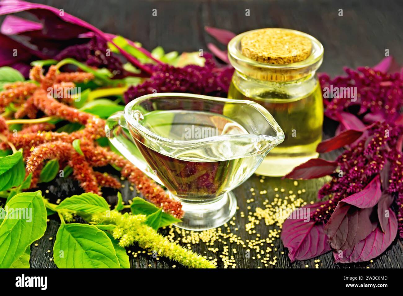 Amaranth oil in a glass gravy boat and jar, brown, green and purple ...