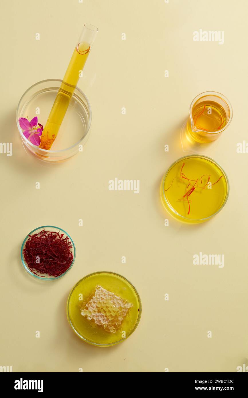 Top view of some lab glasswares containing essence, honey and stigmas ...