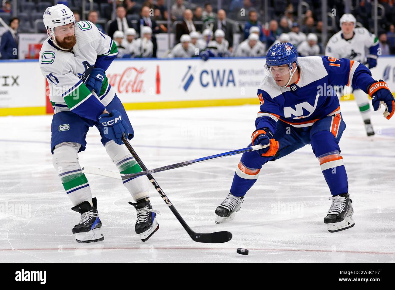 Vancouver Canucks defenseman Filip Hronek clears the puck past New York ...