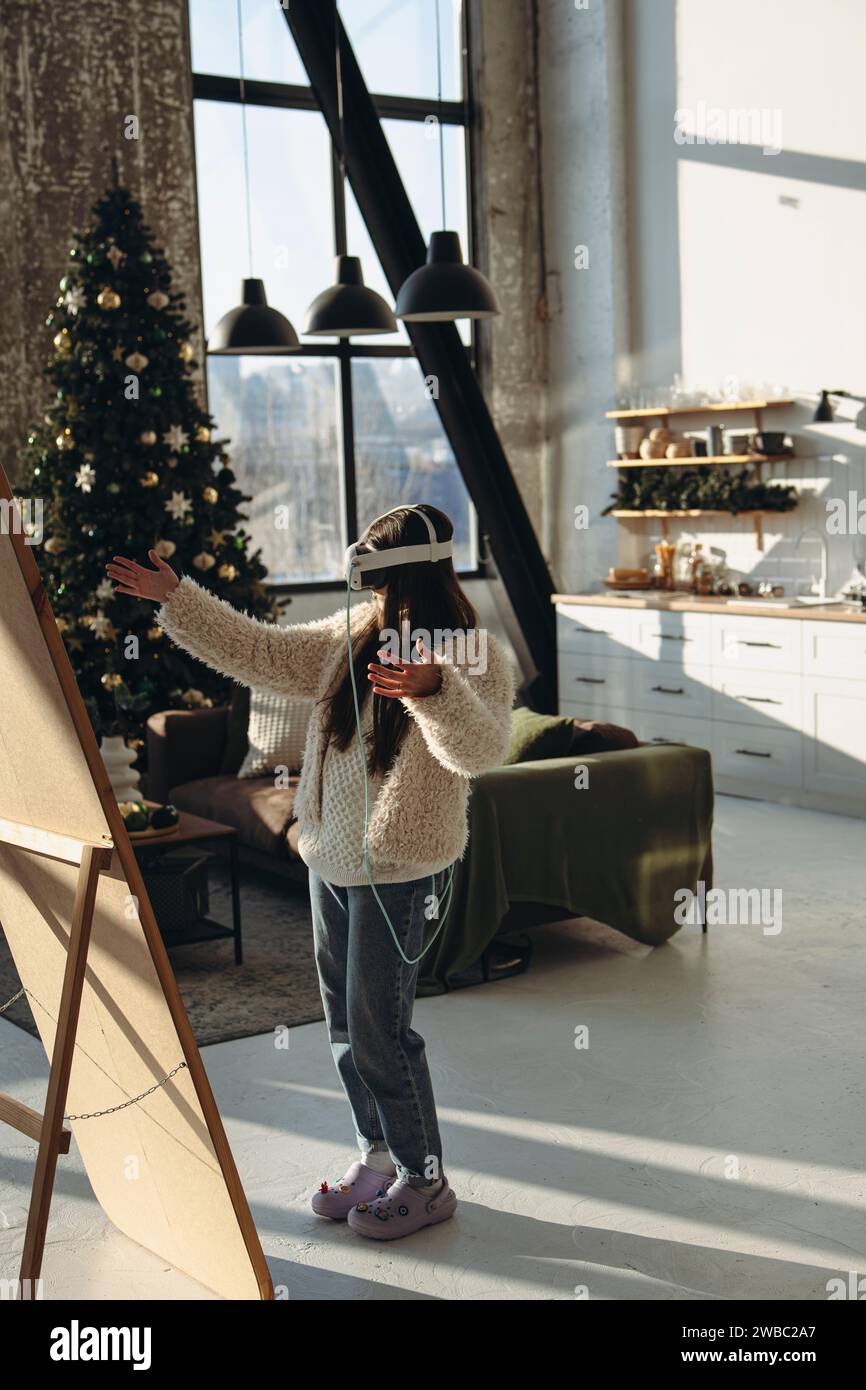 In the midst of Christmas cheer, a young lady in light attire and a VR ...