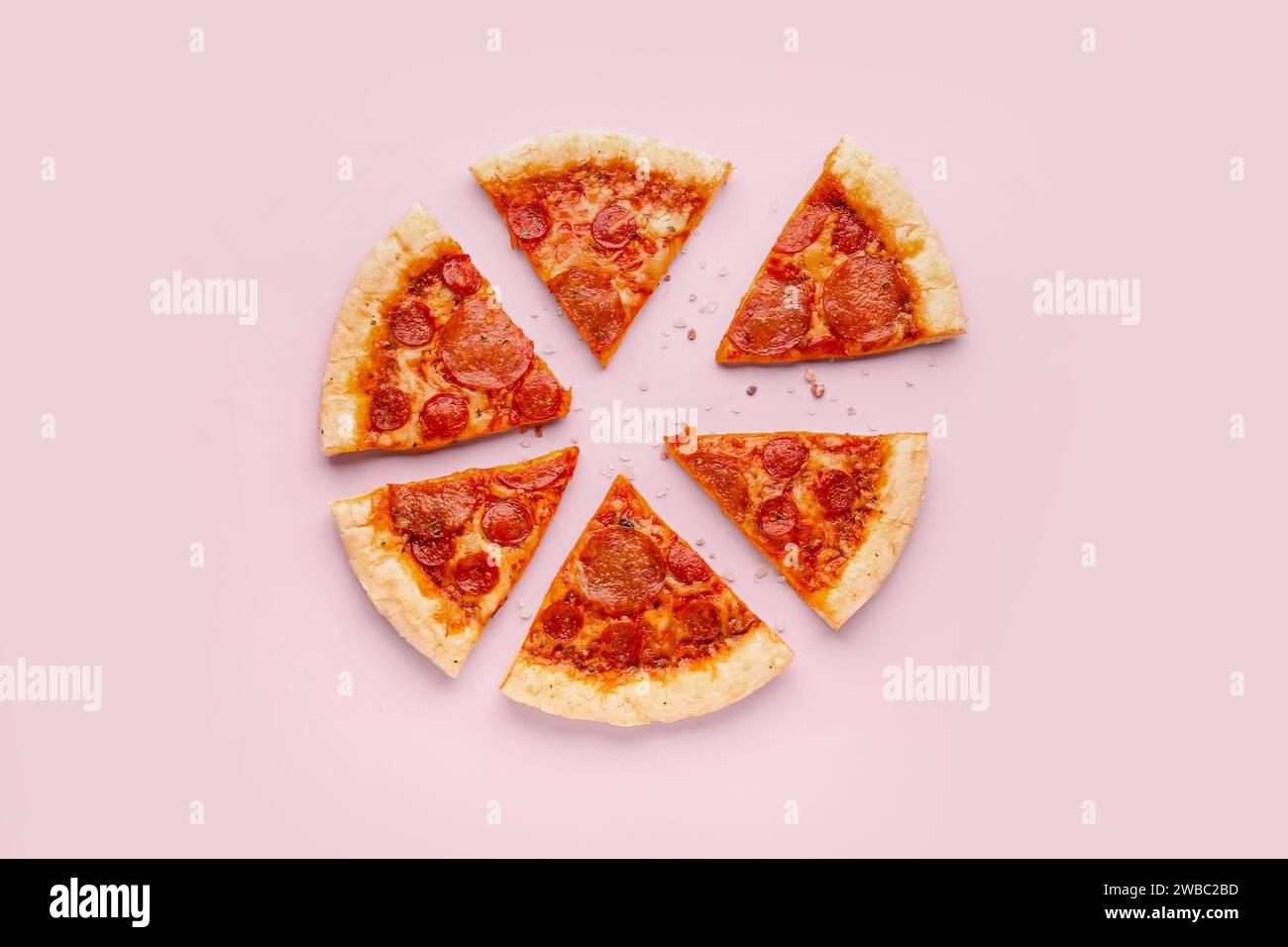 Slices of delicious pepperoni pizza on pink background Stock Photo - Alamy