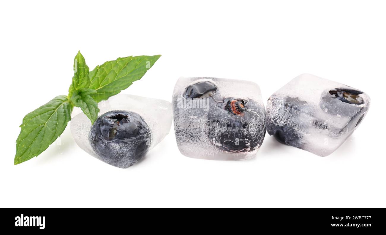 Fresh blueberry frozen in ice cubes and mint on white background Stock ...