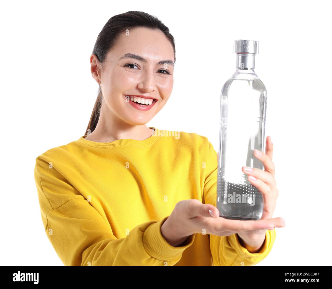 Young woman with bottle of vodka on white background Stock Photo - Alamy