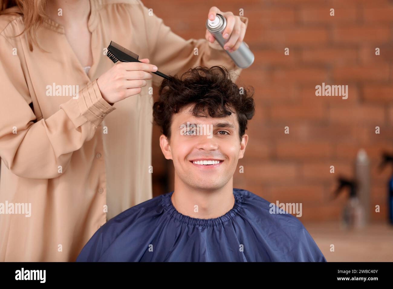 Hairdresser applying hair spray hi-res stock photography and images - Alamy
