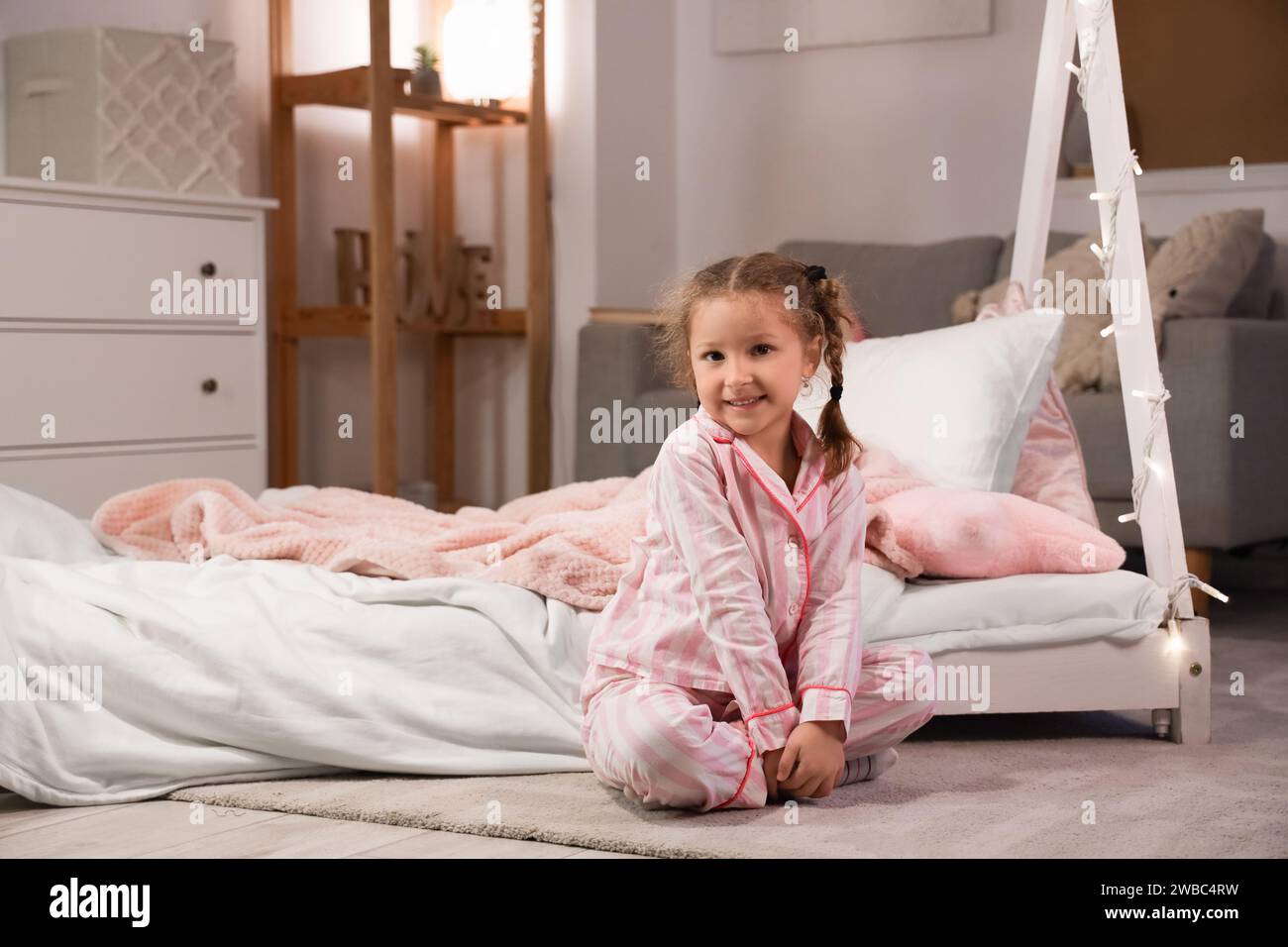 Cute little girl in bedroom at night Stock Photo - Alamy