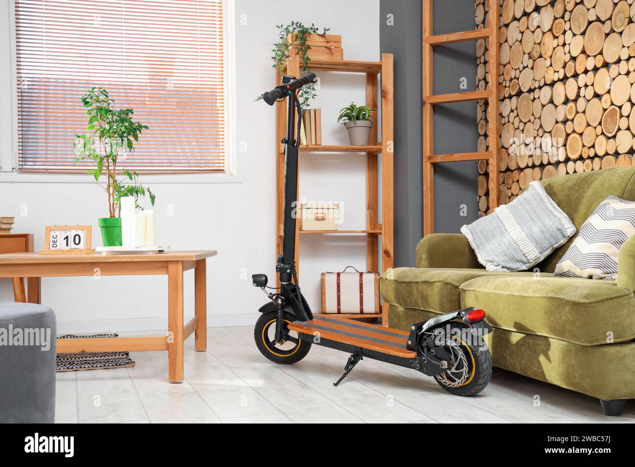 Interior of bedroom with electric scooter and sofa Stock Photo - Alamy