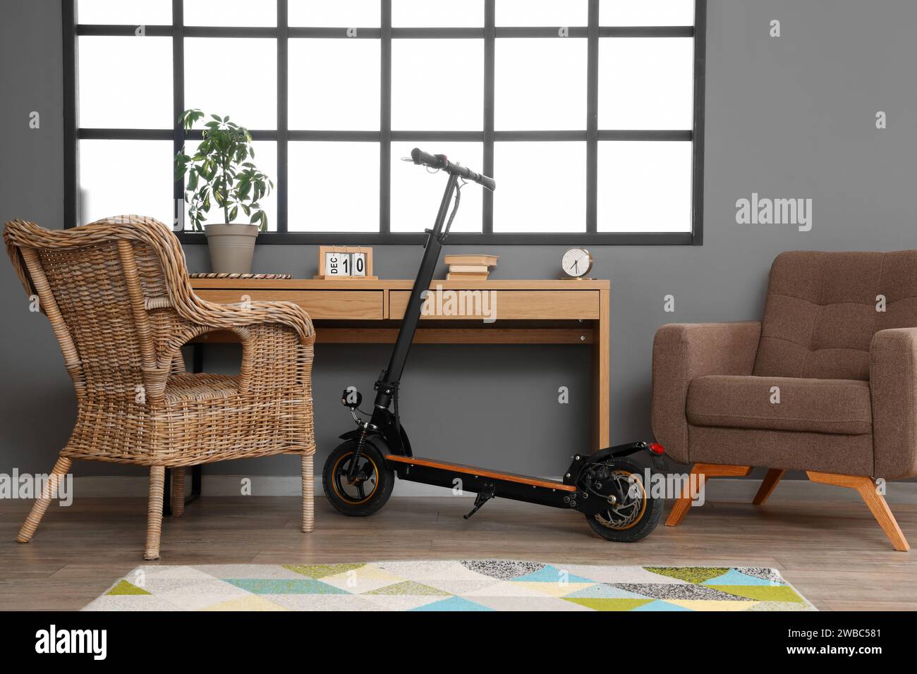 Interior of modern living room with electric scooter, armchairs and ...