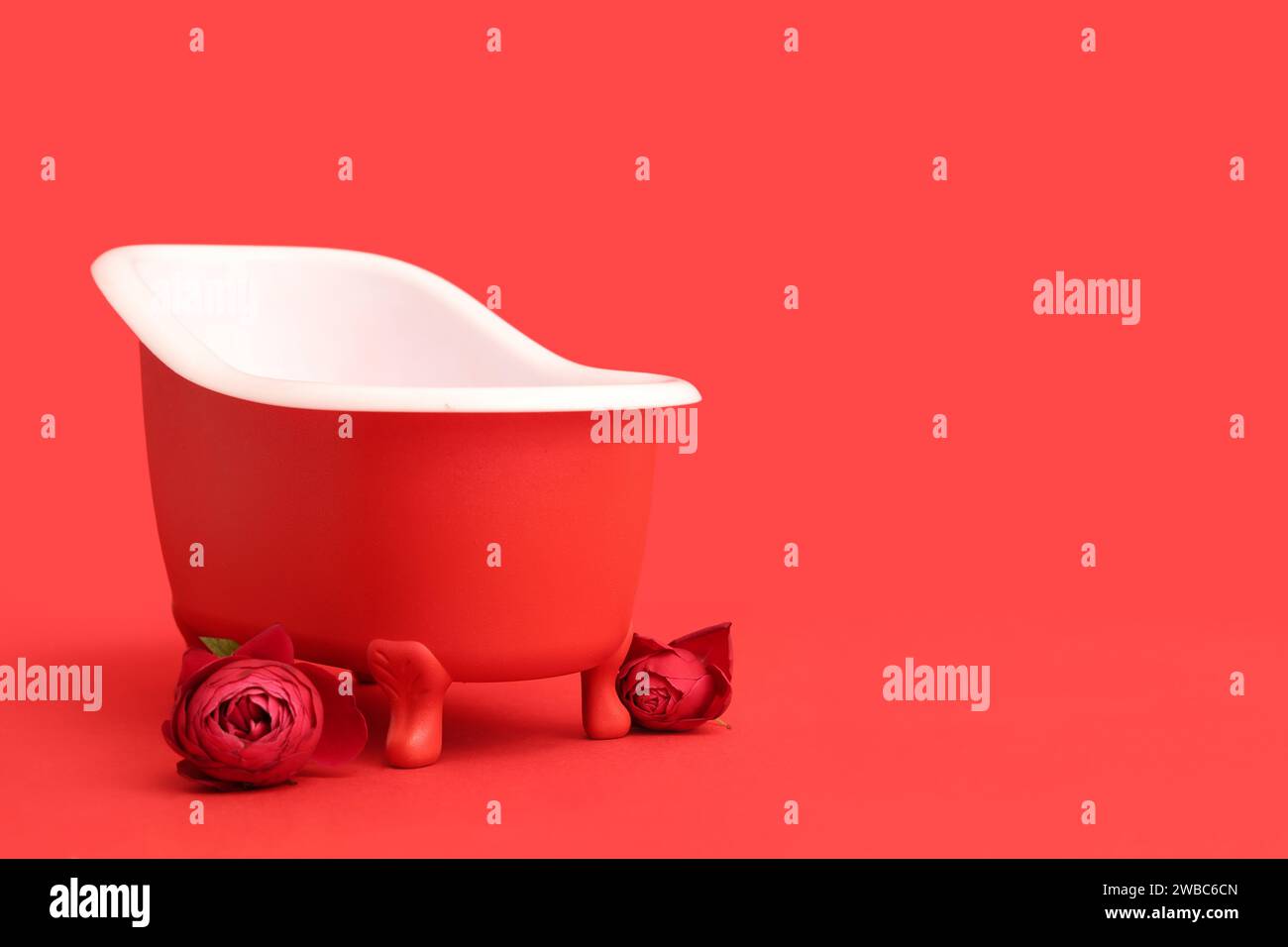 Mini bathtub with roses on red background. Valentine's Day celebration ...