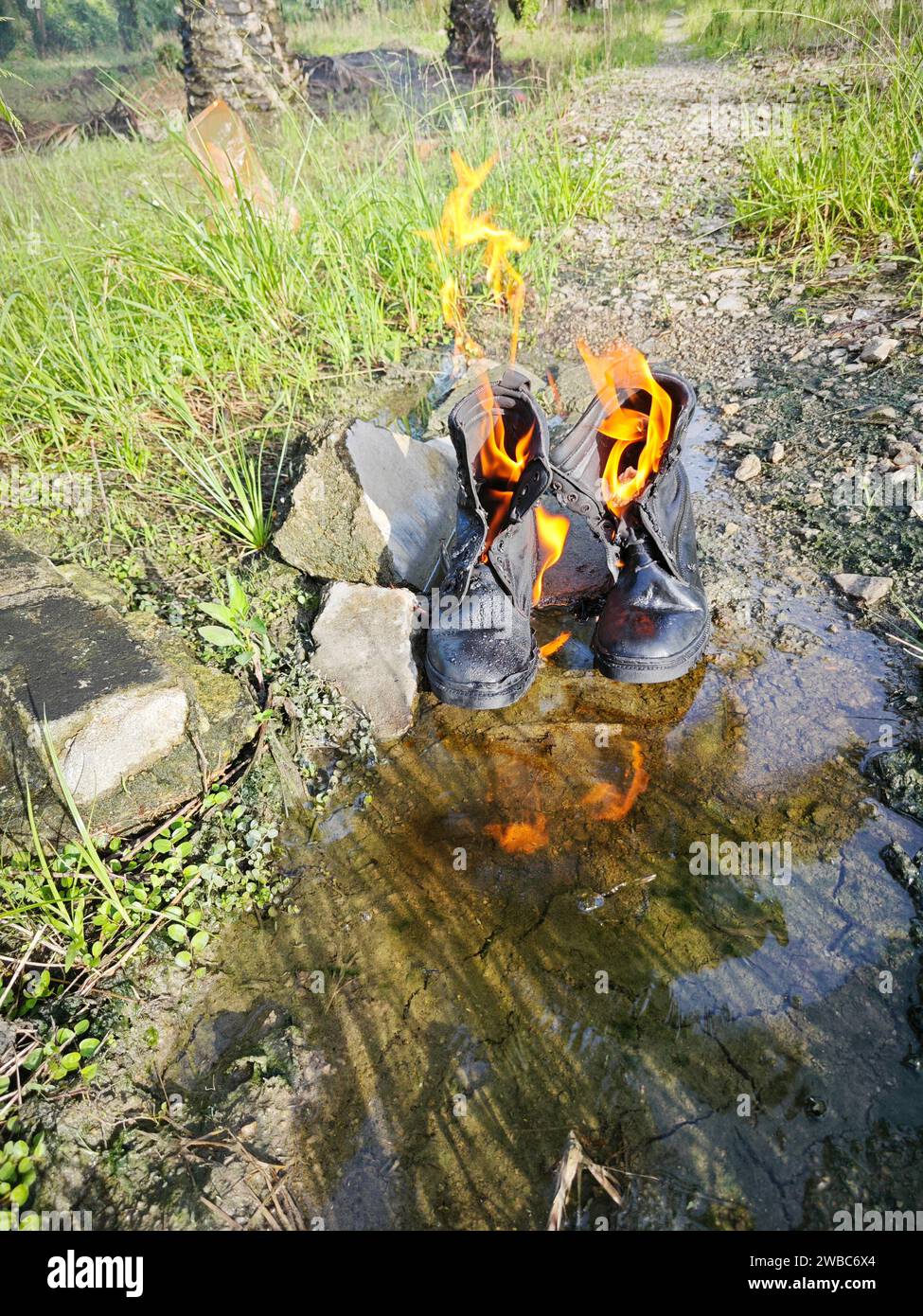 old thrown away leather boot on flame in the farm Stock Photo - Alamy