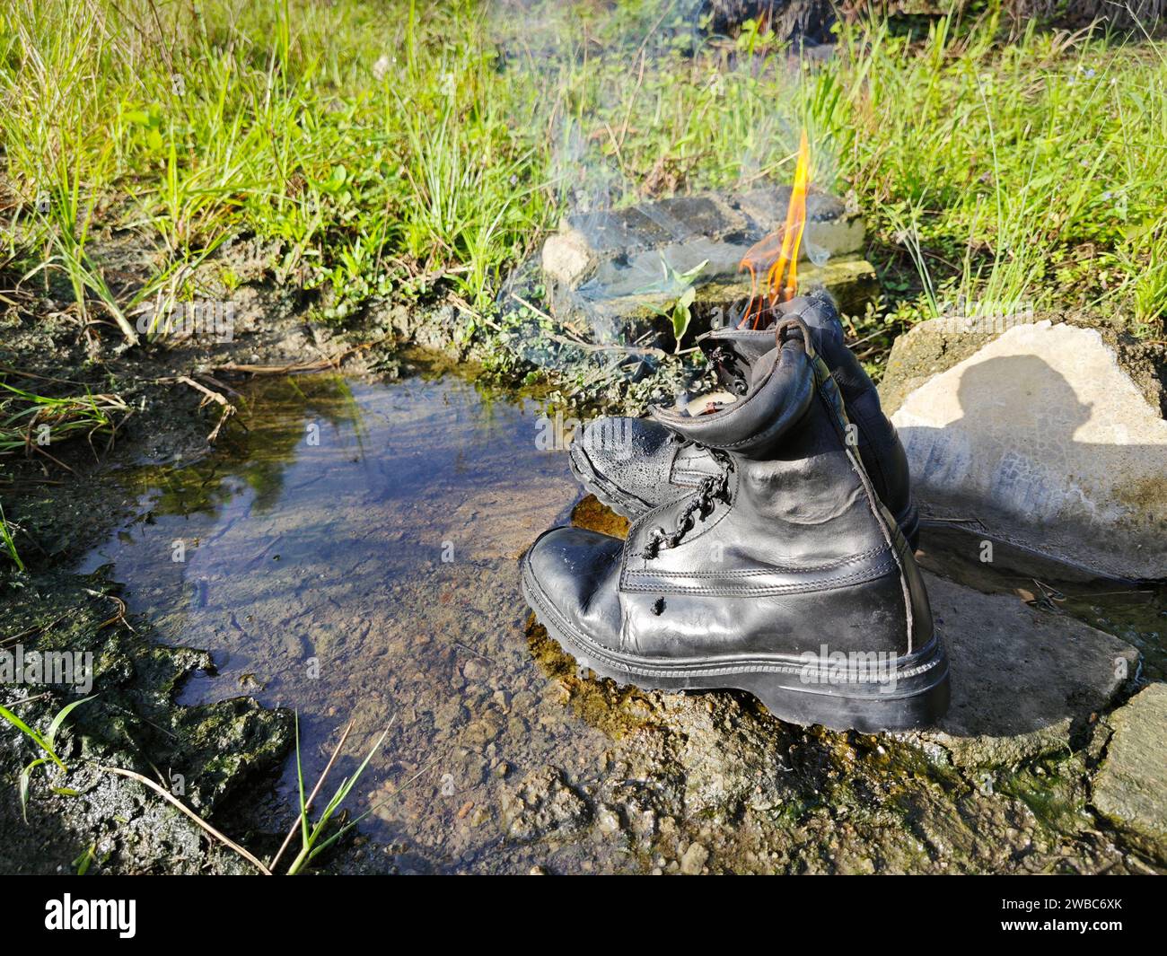 old thrown away leather boot on flame in the farm Stock Photo - Alamy