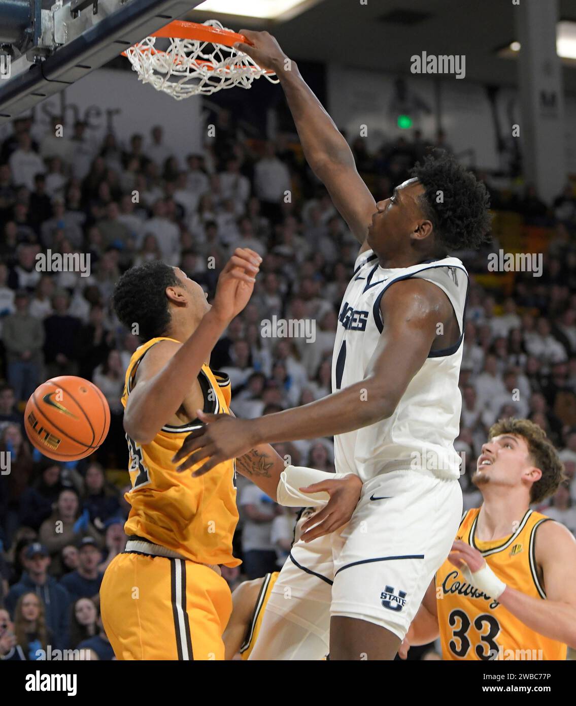 Utah State forward Great Osobor dunks as Wyoming forward Caden Powell ...