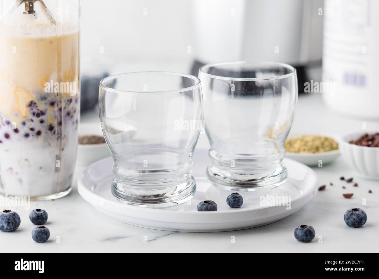 A blender cup full of ingredients to make a healthy blueberry smoothie ...