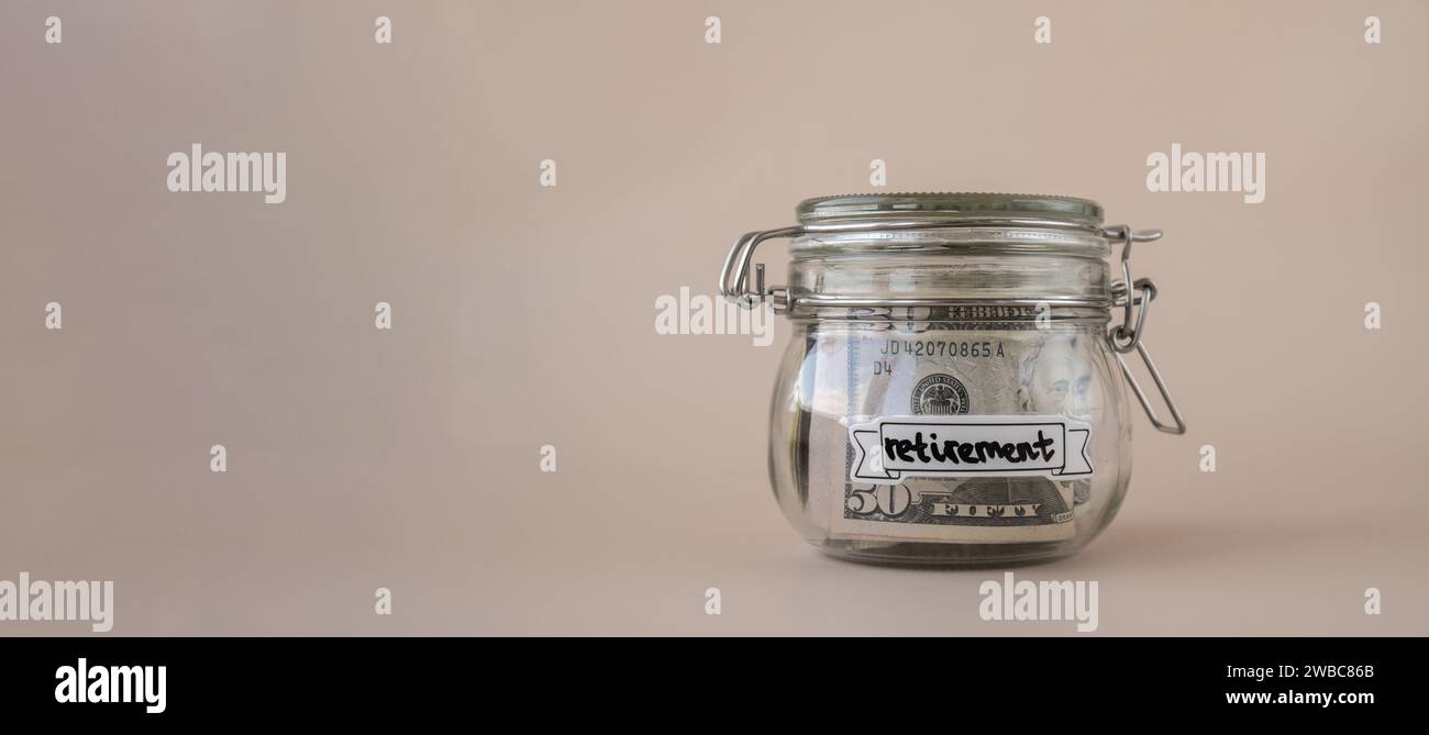 Glass jar full of American currency dollars cash banknote with text ...