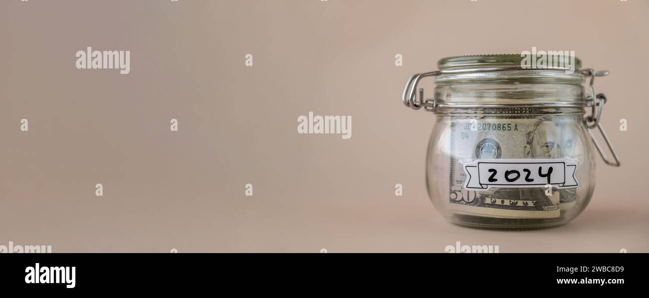 Glass jar full of American currency dollars cash banknote with text ...