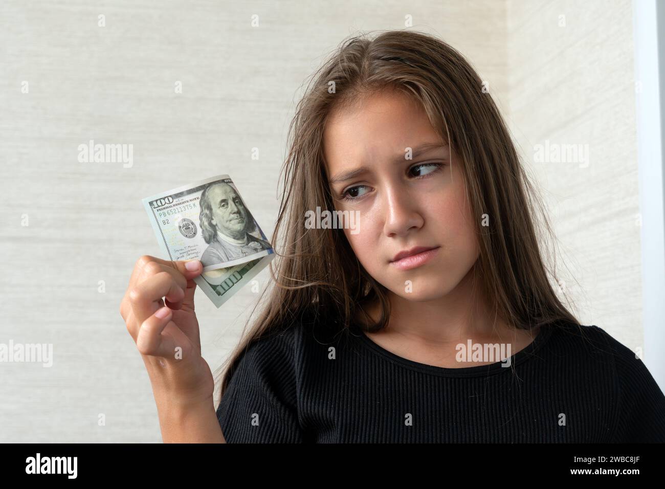 Sad child with money dollar. Not enough money. white background Stock ...