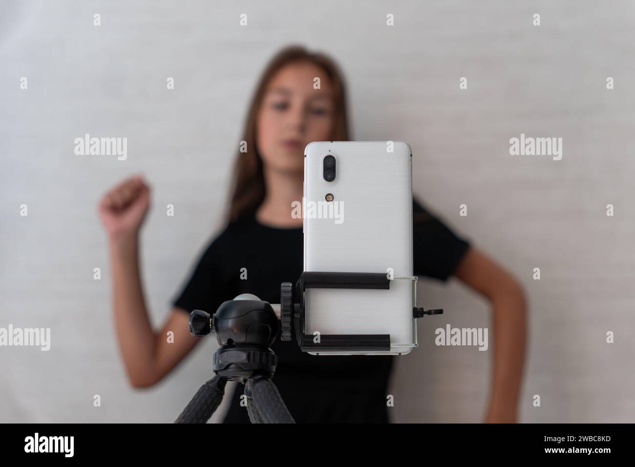 Happy young girl blogger front of phone camera record video enjoy with ...
