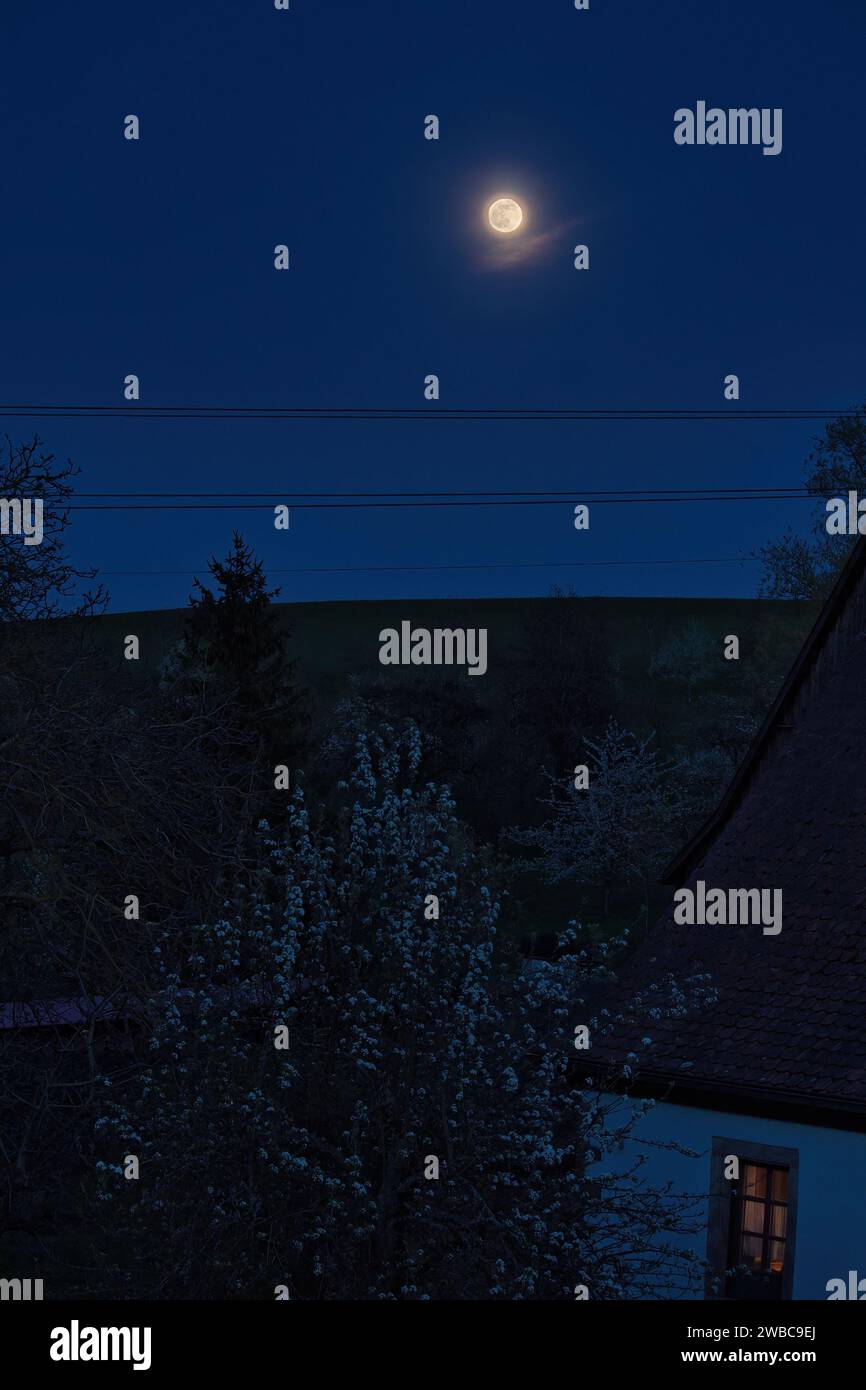 Full moon in a dark blue sky on a spring night in Potzbach, Germany ...