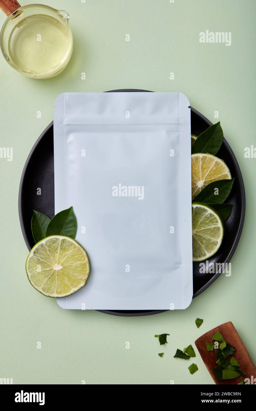 Top view of mockup of a facial sheet mask package on round plate with ...