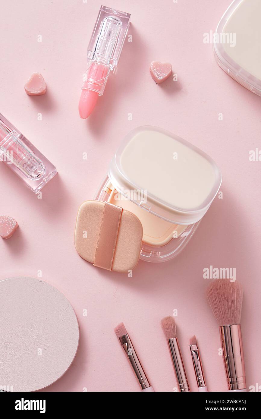 Creative flat lay background of a makeup set with an unlabeled water ...