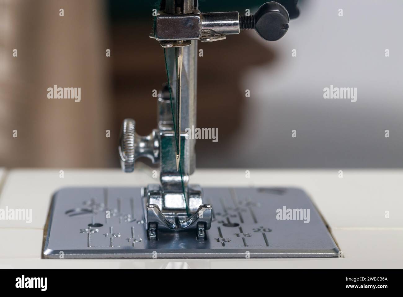 Sewing machine needle with thread close up Stock Photo - Alamy
